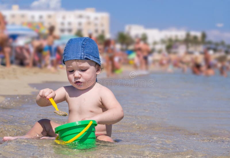 Cute Kid Playing on the Beach with Sand and Water. Stock Photo - Image ...