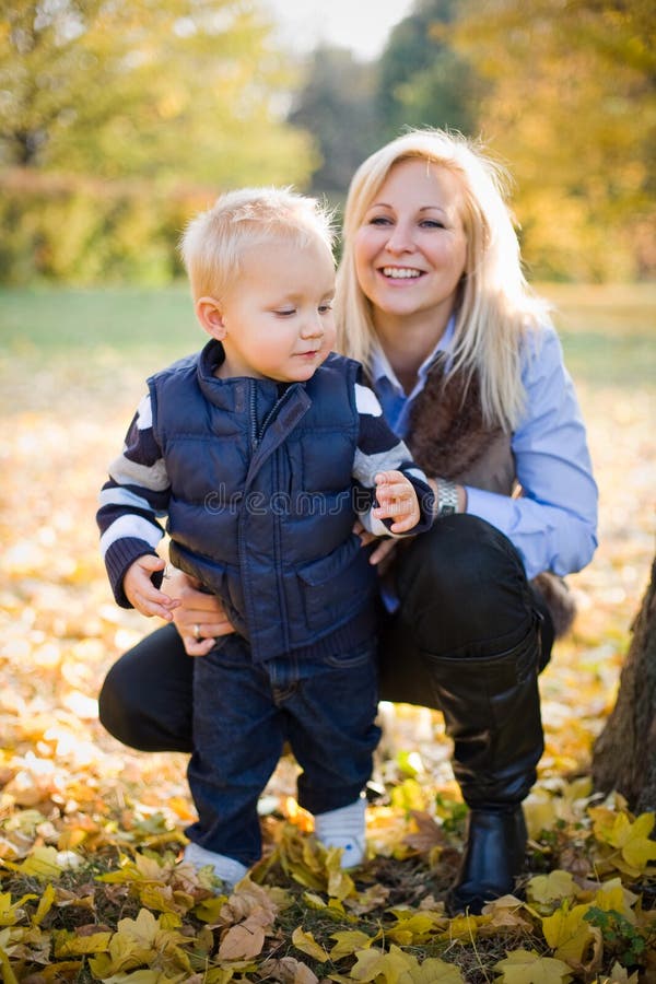 Cute Kid and Pretty Mom Outdoors at Fall. Stock Photo - Image of ...