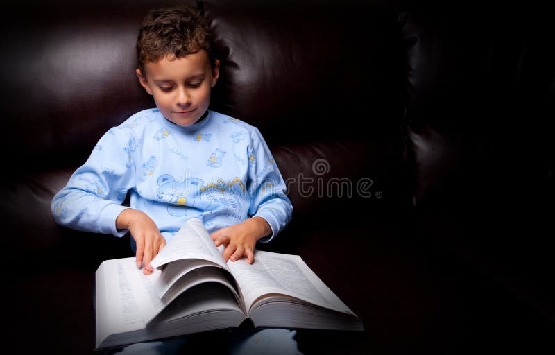 Cute Kid Reading a Big Book on a Sofa Stock Photo - Image of read ...