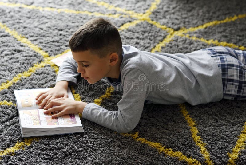Cute Kid Reading a Book on the Floor Editorial Stock Image - Image of ...
