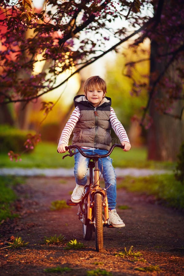 Cute Kid Riding a Bicycle through the Spring Park Stock Image - Image ...