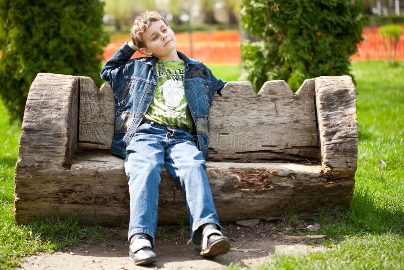 Cute kid sitting on bench stock image. Image of smile - 13755689