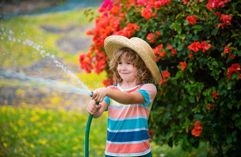 Cute Kid in Straw Hat is Laughing with Water Spraying Hose Stock Photo ...