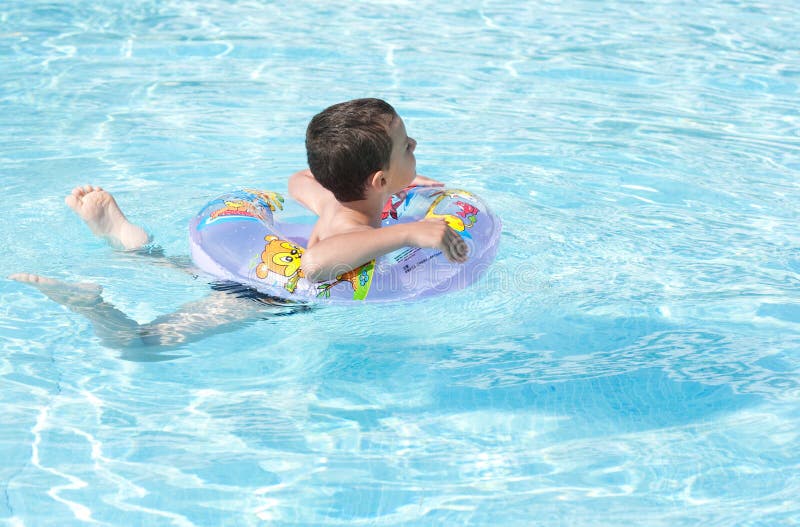 Cute kid swimming in pool stock photo. Image of secured - 10273766