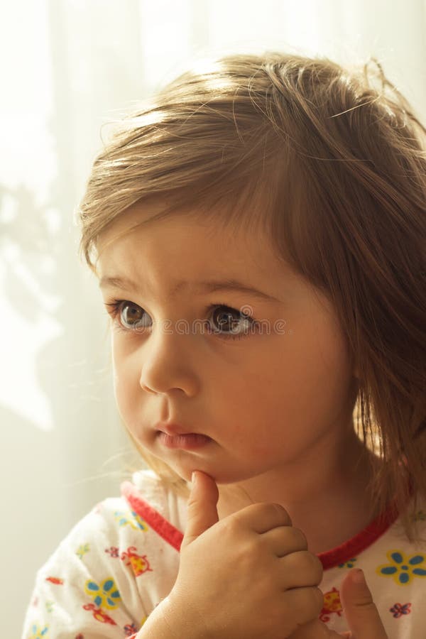 Cute kid thinking outdoors stock image. Image of cheeky - 50076005