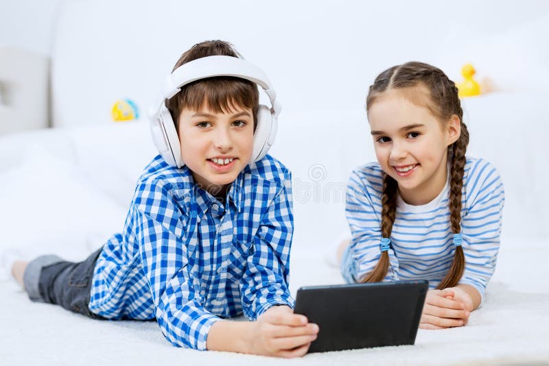 Cute kids gaming on tablet stock image. Image of playing - 68083419