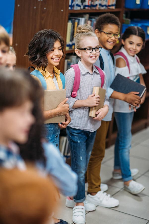 Cute Kids in Library Standing in Row Stock Image - Image of erudition ...
