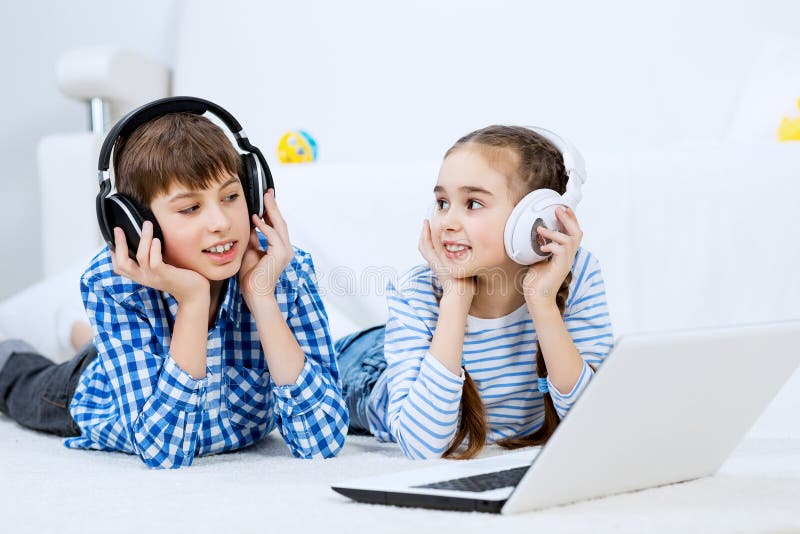 Cute kids using devices stock image. Image of headphones - 66440591
