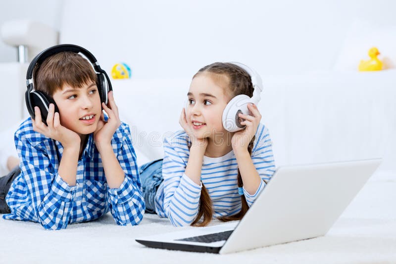 Cute kids using devices stock image. Image of laying - 68083153