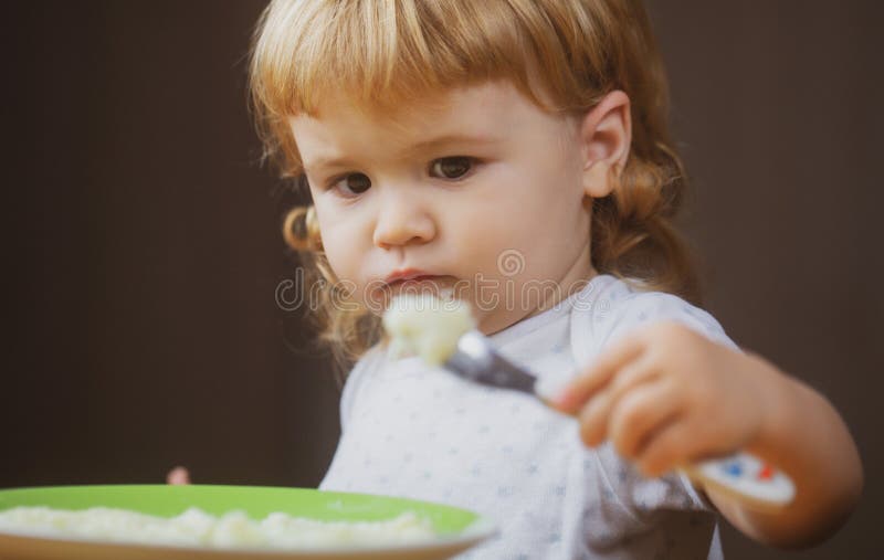 Cute Little Baby is Being Fed Using Spoon. Stock Image - Image of ...