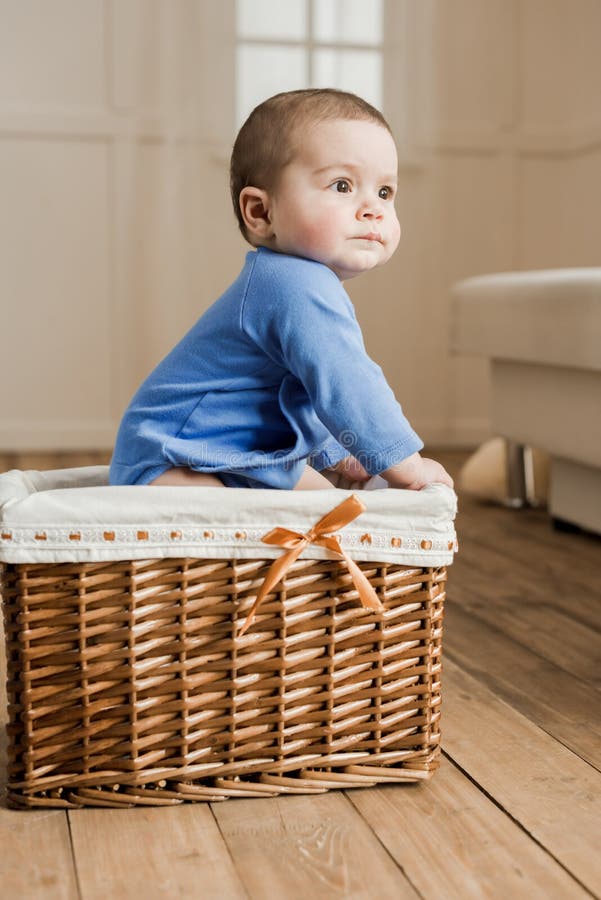 Cute Little Baby Boy Sitting Inside of Braided Box at Home Stock Image ...