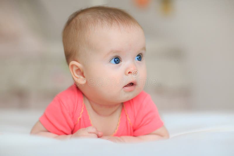 A Cute Little Baby is Looking into the Camera. Little Baby with Blue ...