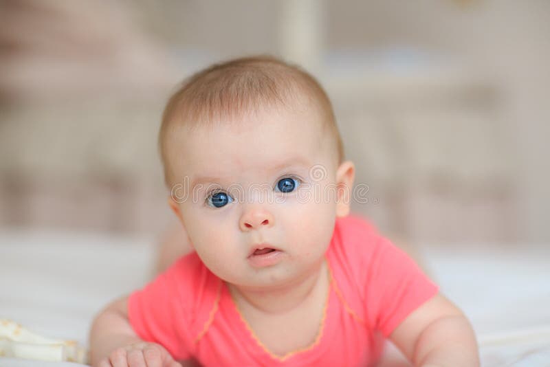 A Cute Little Baby is Looking into the Camera. Little Baby with Blue ...