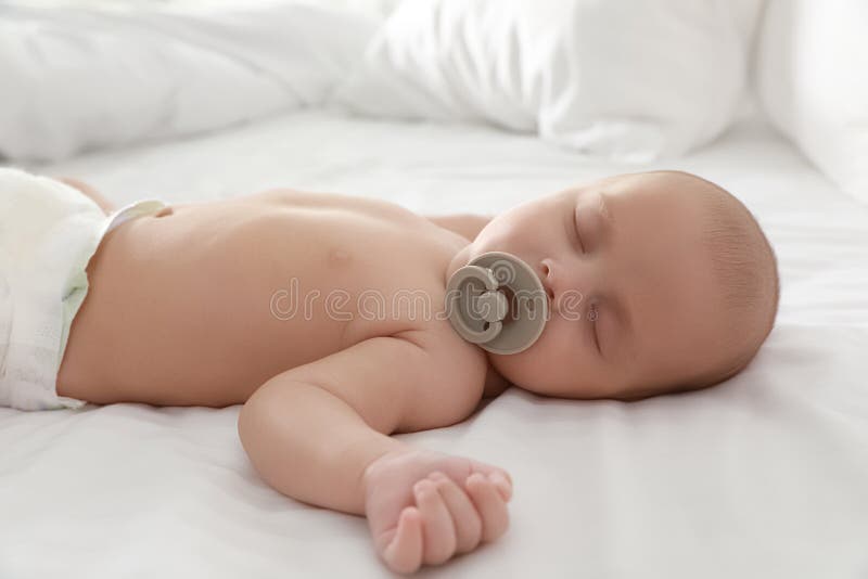 Cute Baby with Pacifier Sleeping on Bed Stock Image - Image of ...