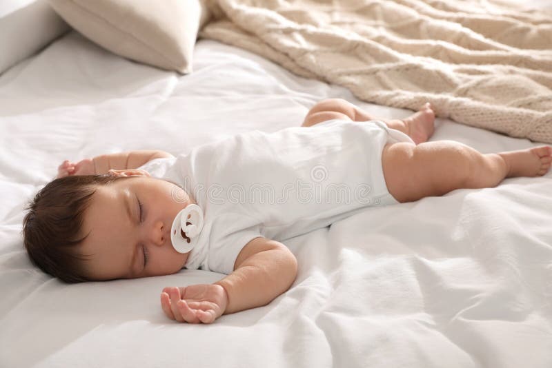 Cute Little Baby with Pacifier Sleeping on Bed Stock Image - Image of ...