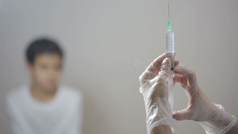 Cute Little Boy Afraid of Injection. Nurse Prepares a Syringe Stock ...