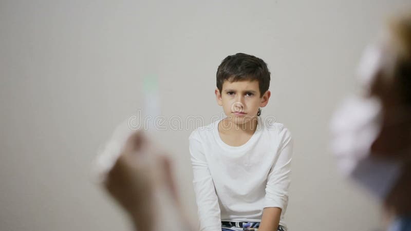Cute Little Boy Afraid of Injection. Nurse Prepares a Syringe Stock ...