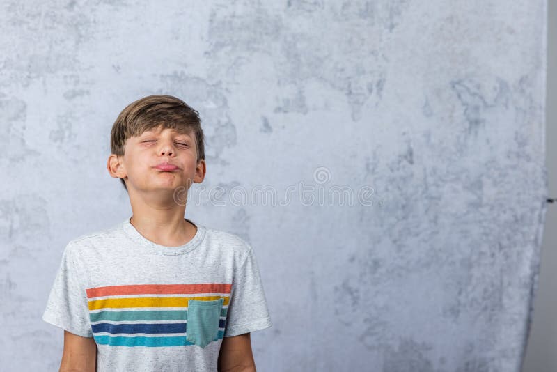 A Cute Little Boy with Autism in a Studio Setting Making a Pouty Face ...