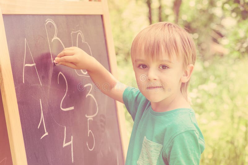 Cute Little Boy at Blackboard Practicing Counting and Math Outdoor ...
