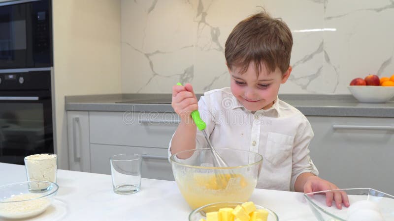 Cute Little Boy Cooking Dough at Table in Kitchen Stock Video - Video ...