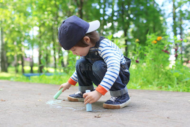 Cute Little Boy Drawing Chalk on the Ground Stock Photo - Image of ...