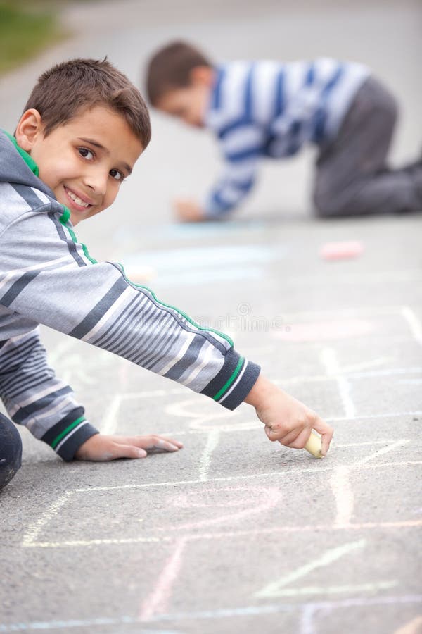 Cute Little Boy Drawing with Chalk Outdoors Stock Photo - Image of ...