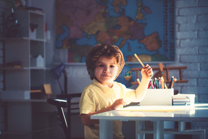 Cute Little Boy Drawing at Desk at the Nursery School. Stock Photo ...