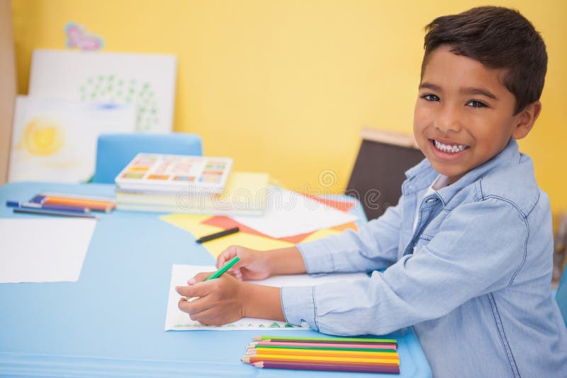 Cute Little Boys Reading at Desk in Classroom Stock Photo - Image of ...