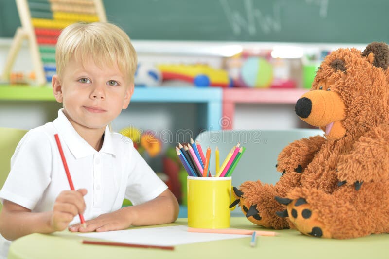 Cute Little Boy Drawing with Pencils in Classroom Stock Image - Image ...