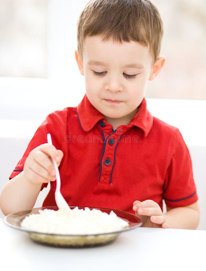 Cute Little Boy is Eating Cottage Cheese Stock Photo - Image of calm ...