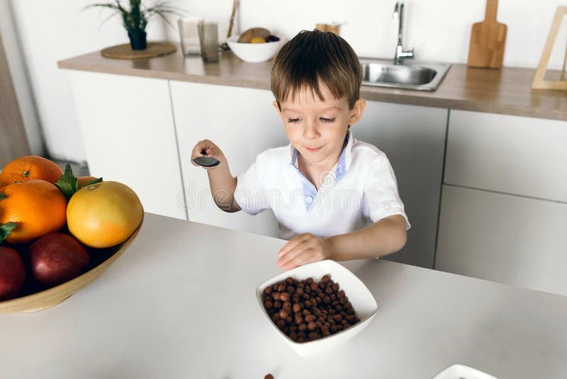 Cute Little Boy Eating Dry Breakfast Home Kitchen Stock Photo - Image ...