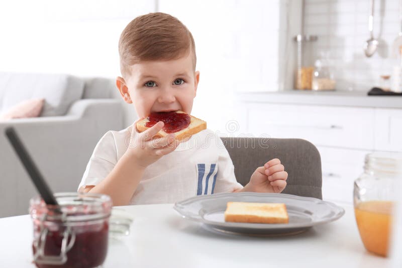 Cute Little Boy Eating Toast with Sweet Jam Stock Photo - Image of ...
