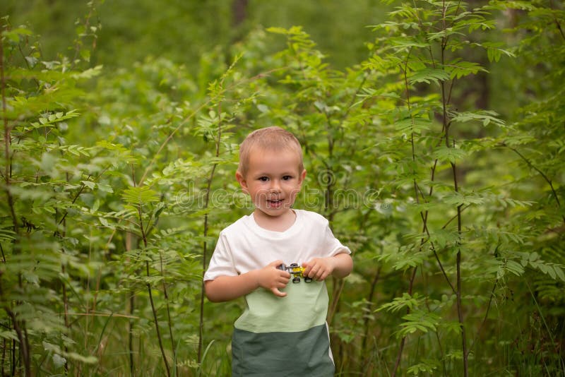 Cute Boy in the Forest Against the Background of Grass Summertime Stock ...