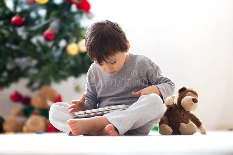 Cute Little Boy and His Monkey Toy, Playing on Tablet Stock Photo ...