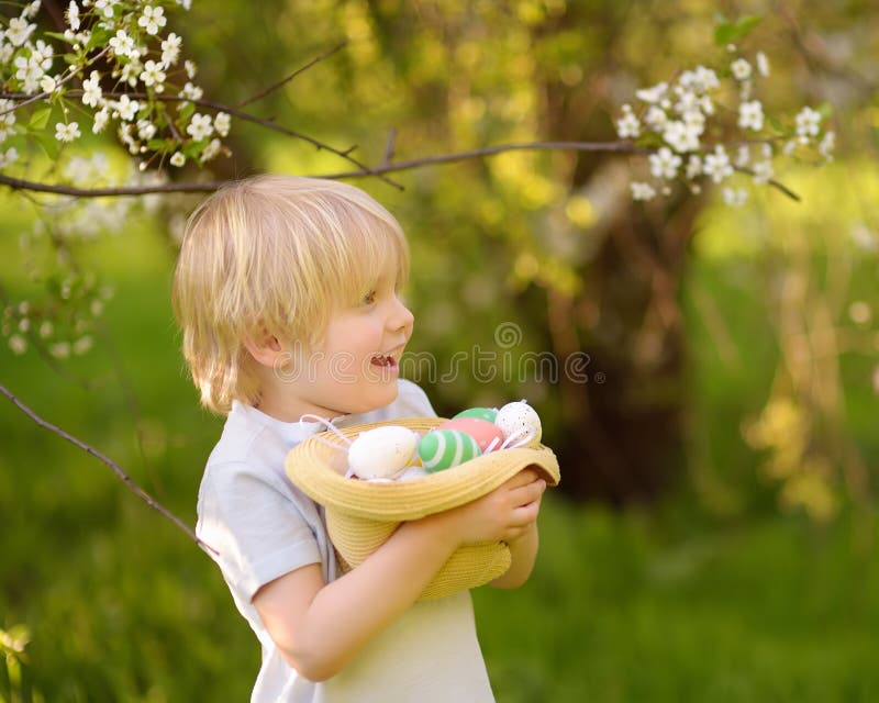 Cute Little Boy Hunts for Easter Egg in Spring Park Stock Image - Image ...