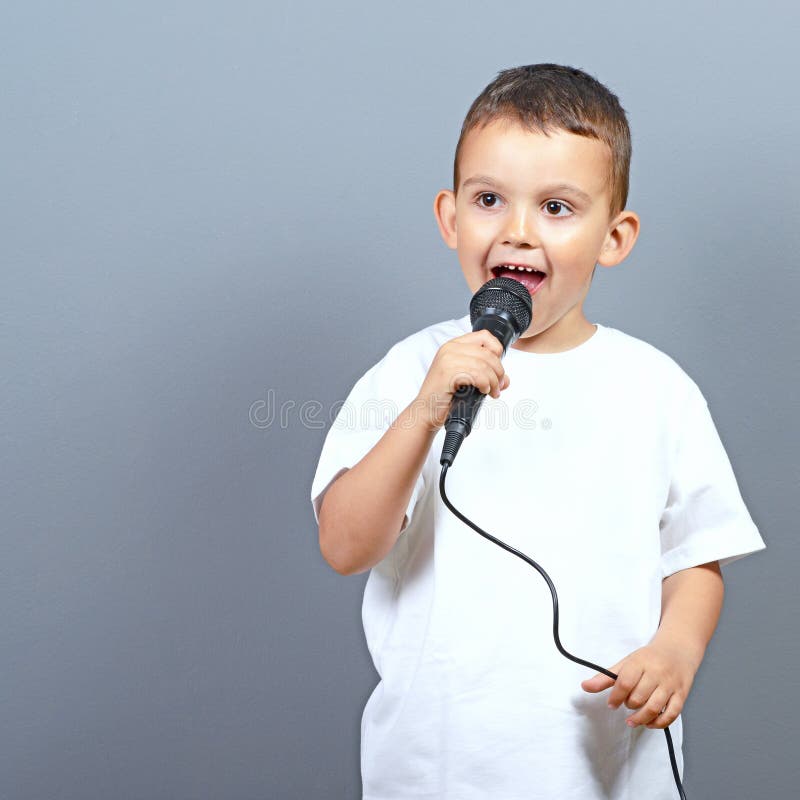 Cute Boy with Microphone in Room Stock Photo - Image of full, person ...