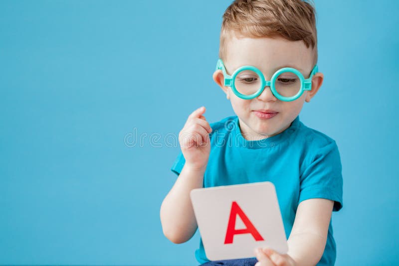 Cute Little Boy with Letter on Background. Child Learn Letters Stock ...