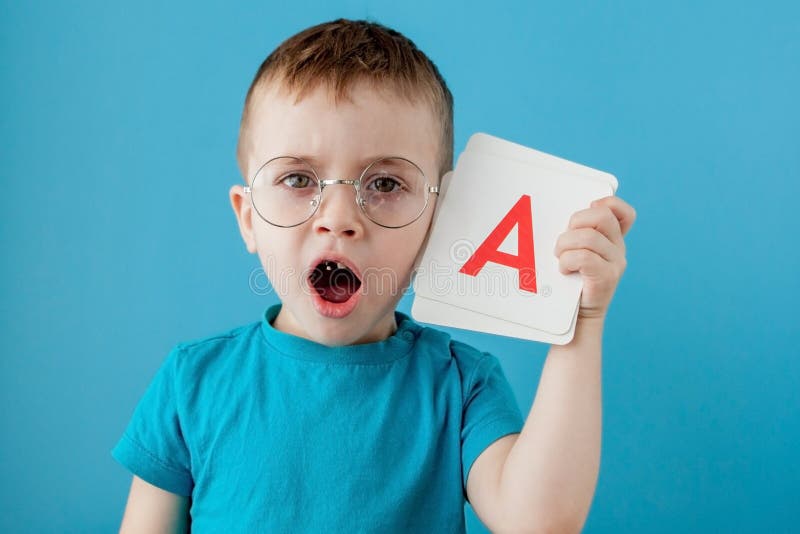 Cute Little Boy with Letter on Blue Background. Child Learning a ...