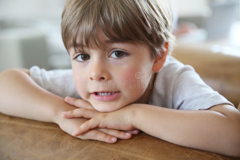 Cute Little Boy Looking at Camera Stock Image - Image of armchair ...