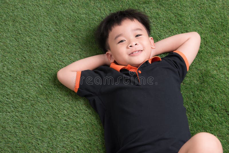 Cute Little Boy Lying on Green Grass Stock Photo - Image of nature ...