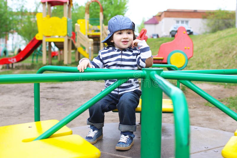 Cute Little Boy on Merry-go-round Stock Image - Image of outside, small ...