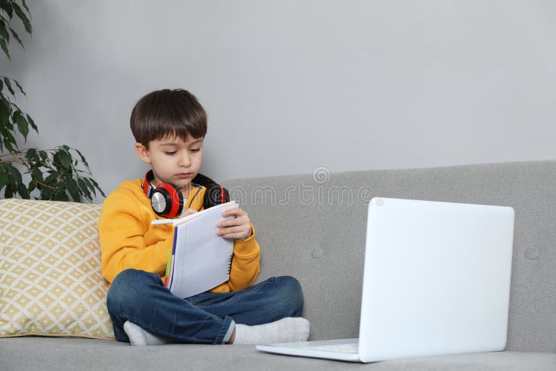 Cute Little Boy with Modern Laptop Studying Online at Home. E-learning ...