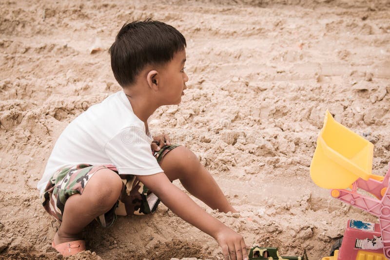 Cute little boy play sand stock photo. Image of child - 76787902