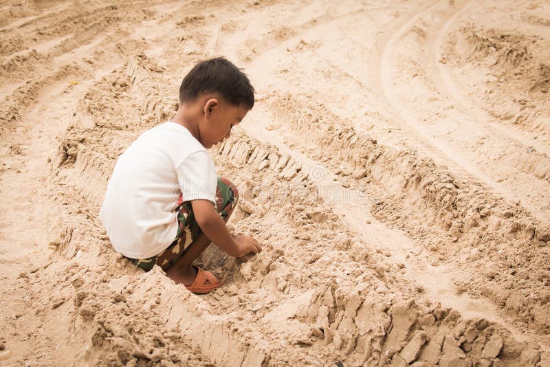 Cute little boy play sand stock photo. Image of child - 76787926