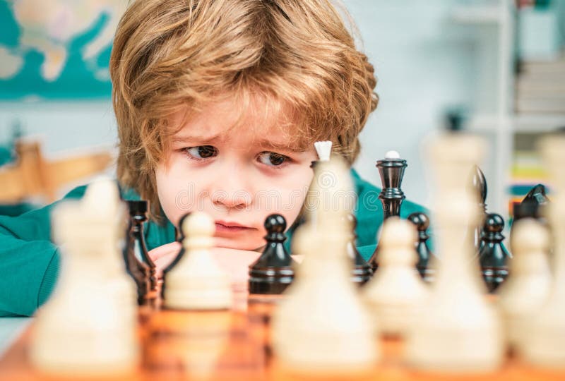 Cute Little Boy Playing Chess. Thinking Kid. Concentrated Boy ...