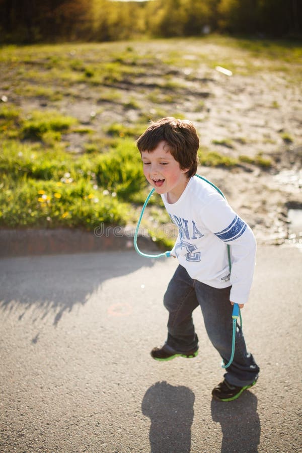 Boy playing jump rope stock image. Image of hour, sunny - 30052043