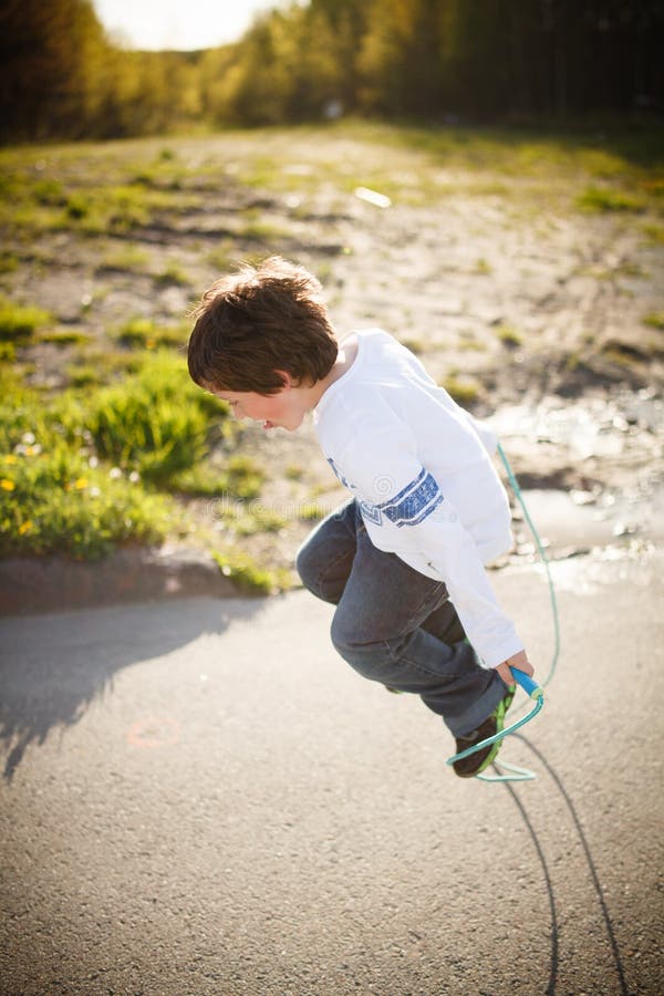 Boy playing jump rope stock image. Image of hour, sunny - 30052043