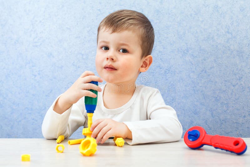 Cute Little Boy is Playing with Tools. a Toddler Working with Toy Tools ...