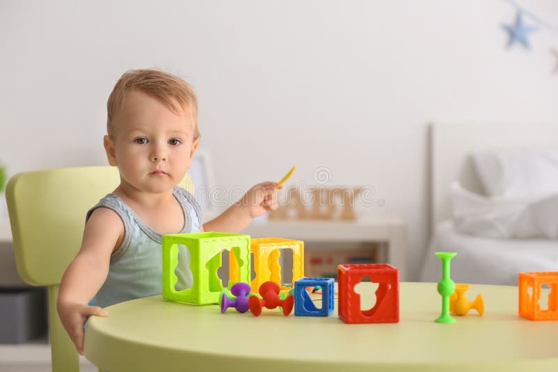 Cute Little Boy Playing with Toys at Table Indoors Stock Photo - Image ...