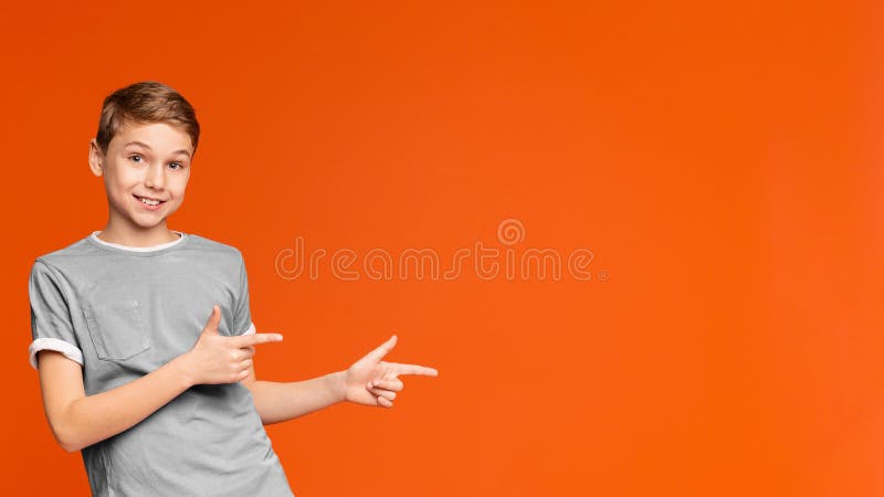 Cute Little Boy Pointing Away on Orange Background Stock Image - Image ...